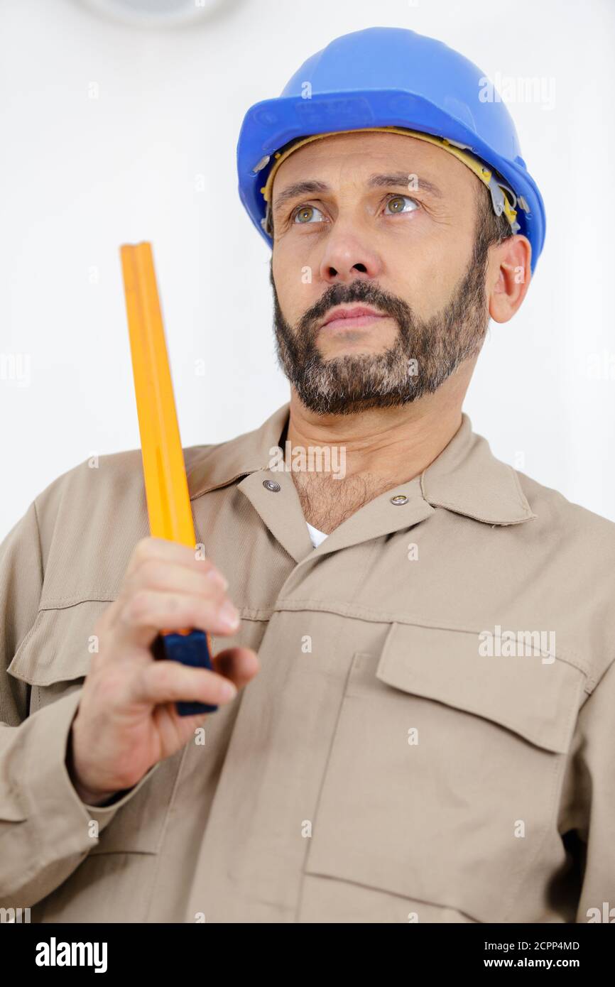 man measuring wood on saw Stock Photo - Alamy