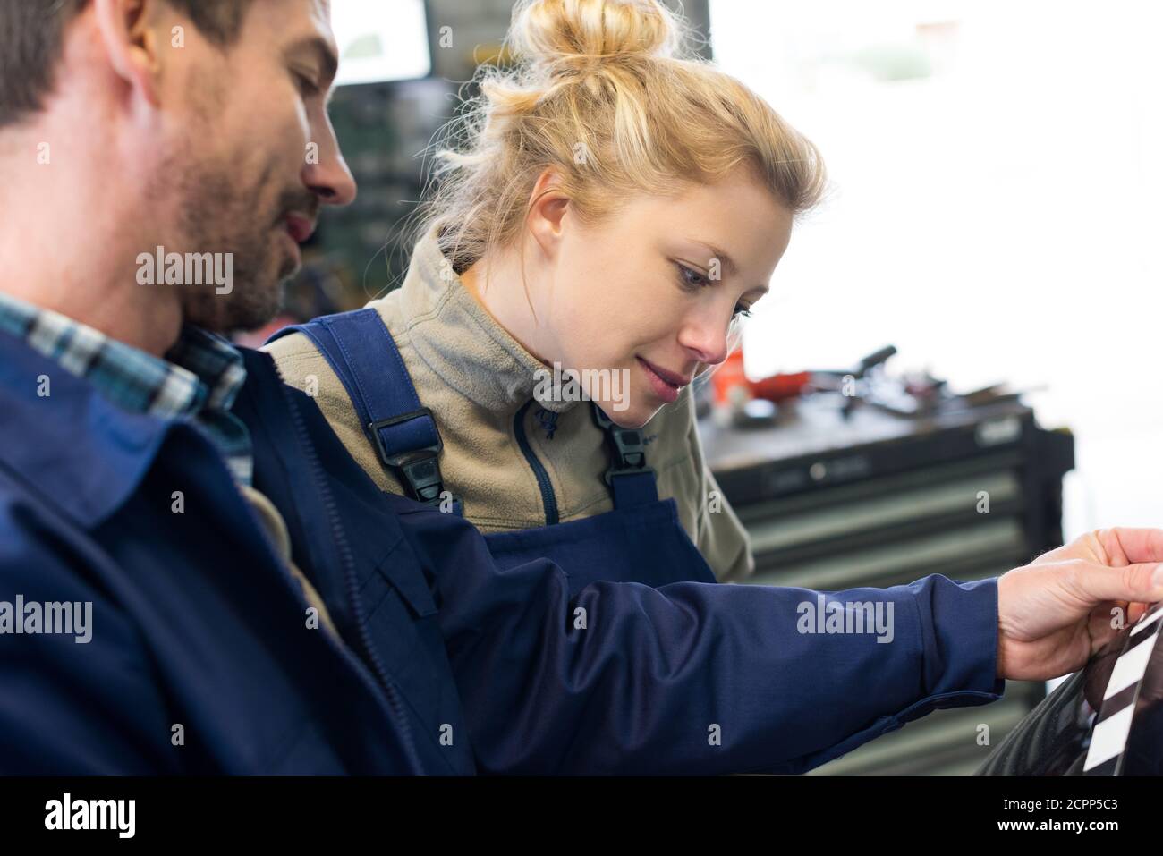 young woman looking curiously at the engine Stock Photo - Alamy