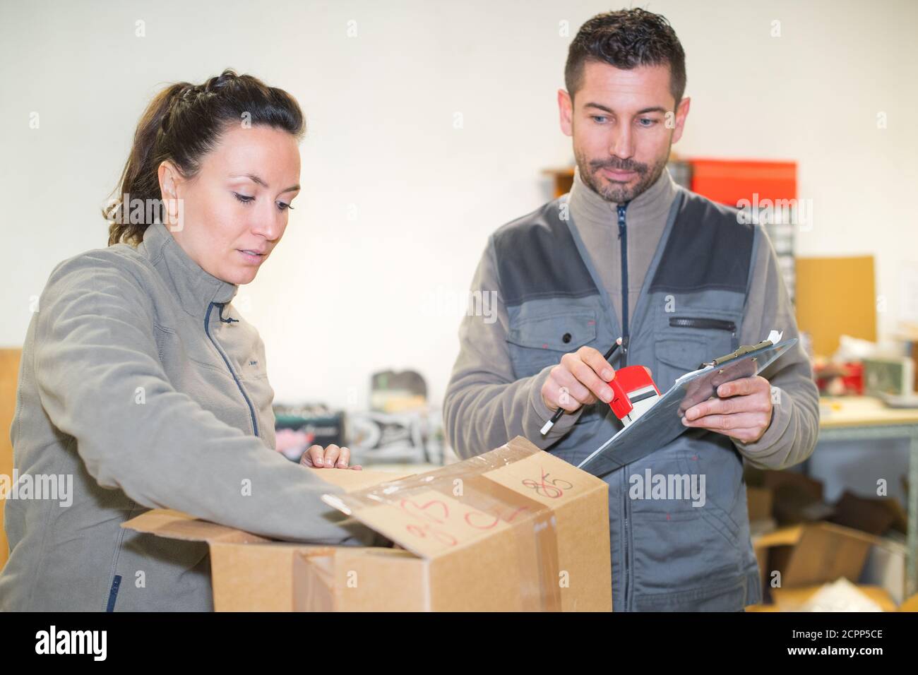 young women worker opening box in warehouse Stock Photo - Alamy