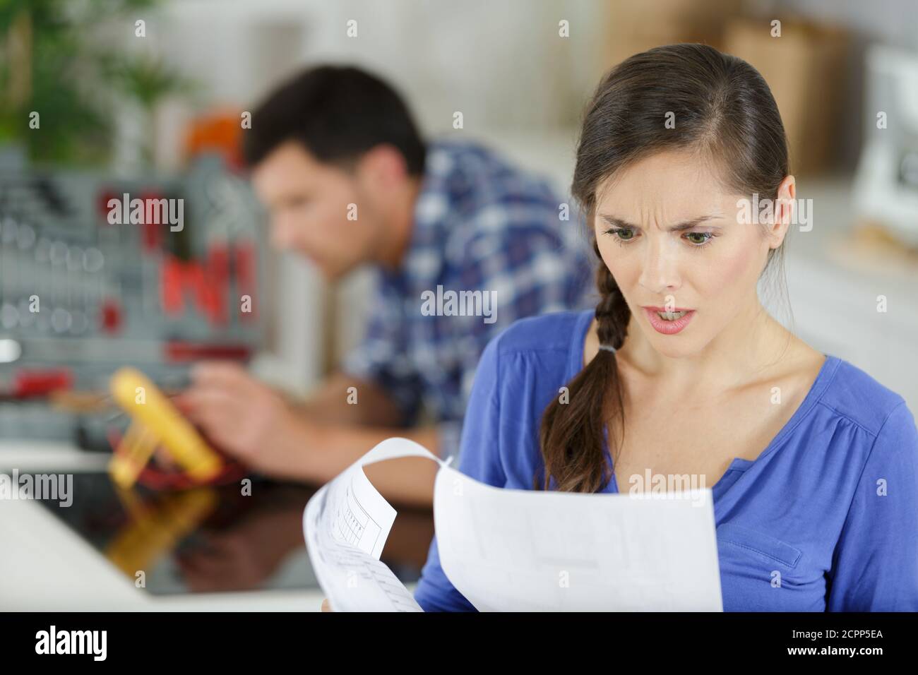 frustrated shocked women looking at expensive bill Stock Photo - Alamy