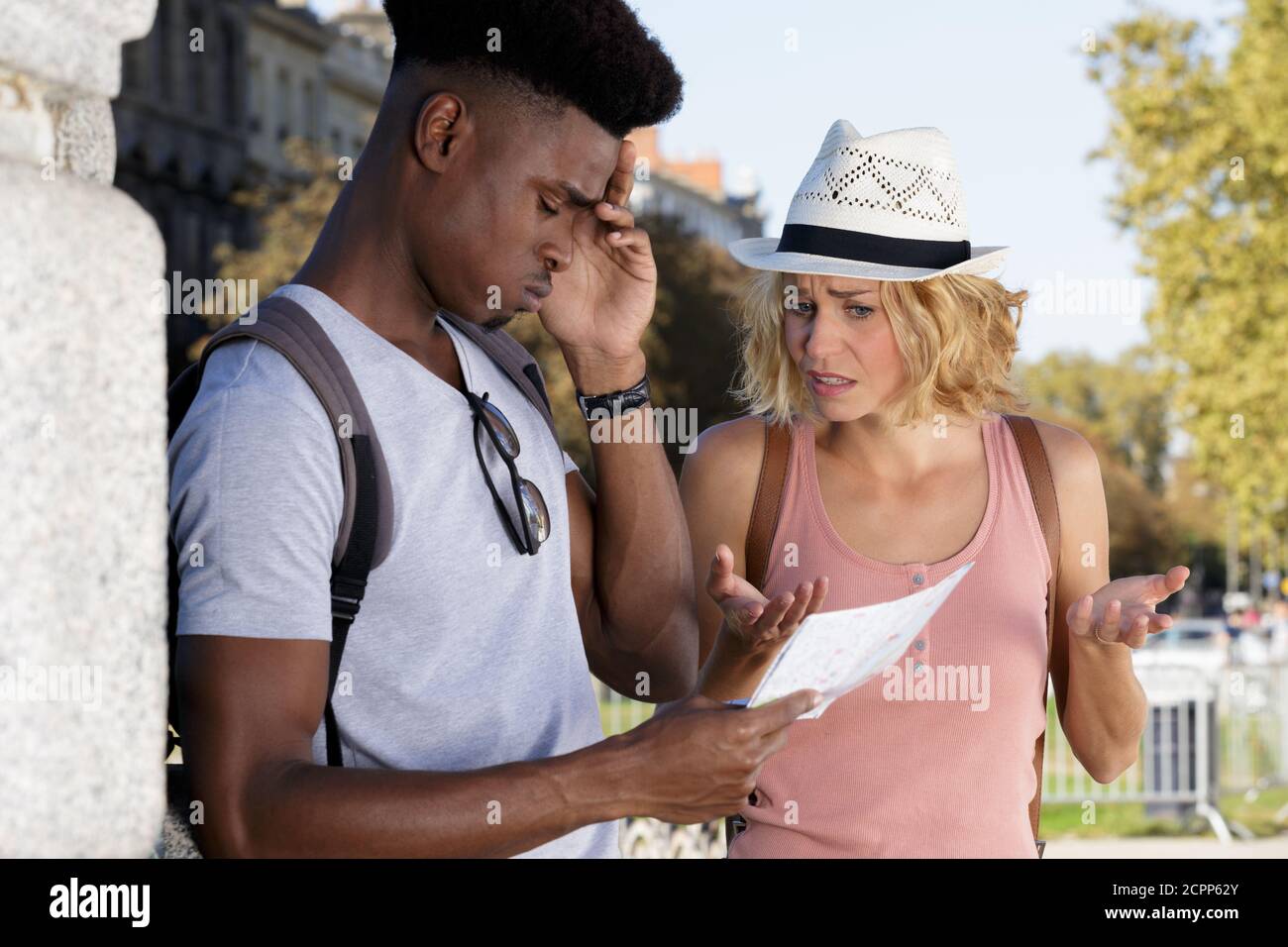 lost couple looking disorientated holding a map Stock Photo - Alamy