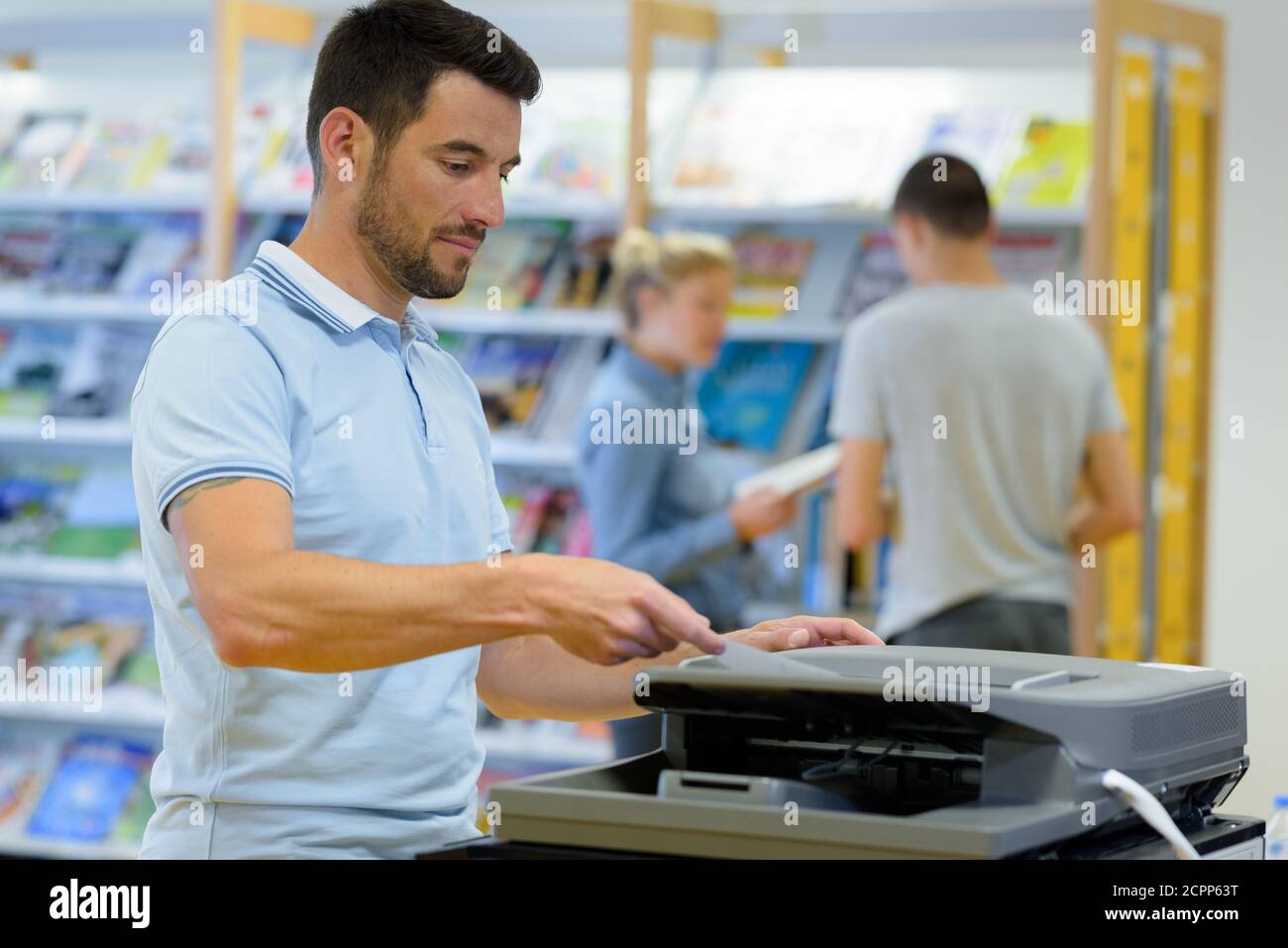 a man using copier machine Stock Photo - Alamy