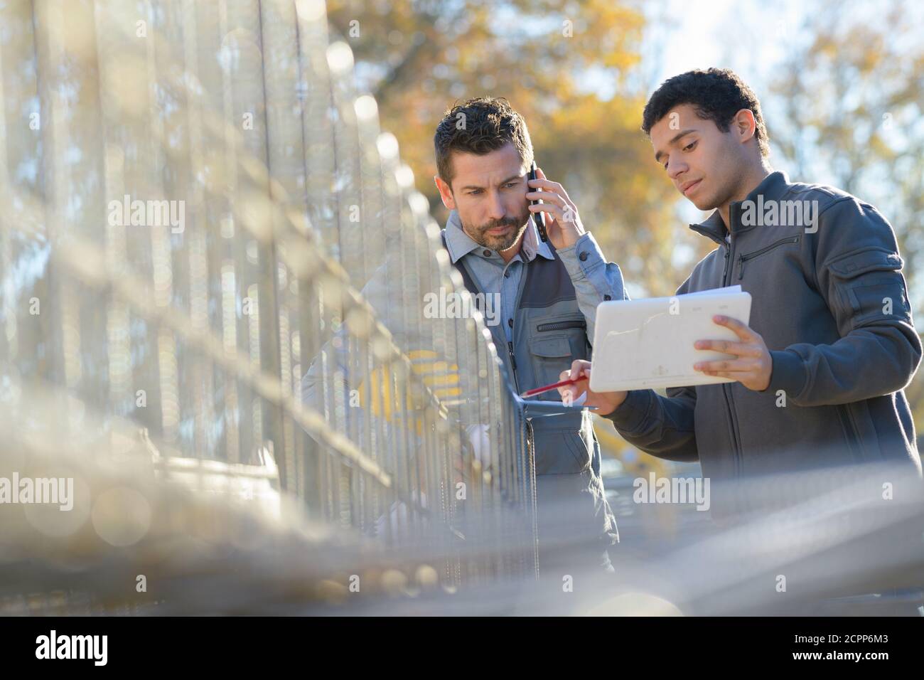 two workmen stood by rebars on construction site Stock Photo - Alamy