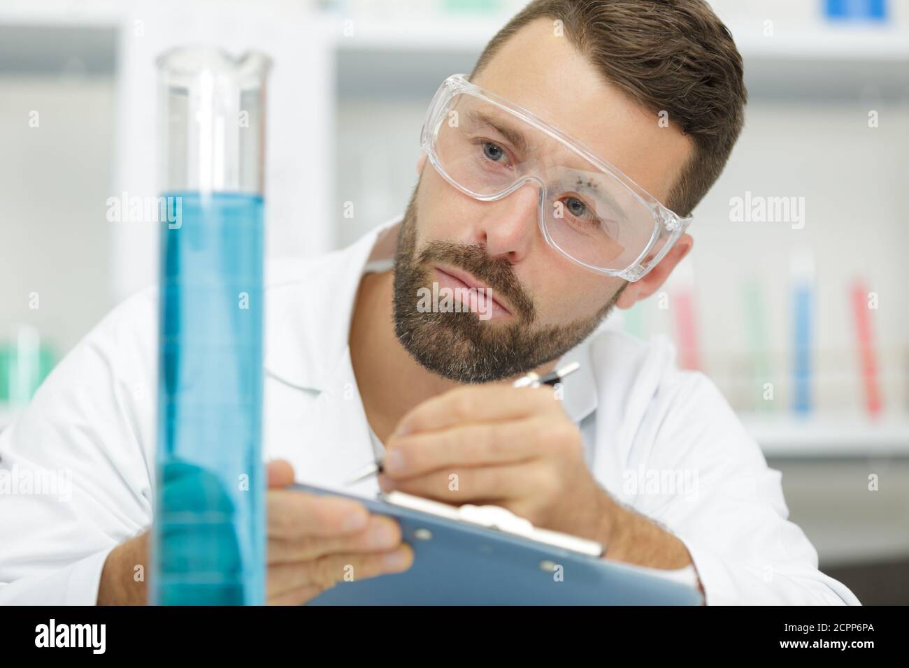 male scientist making notes during experiment Stock Photo - Alamy