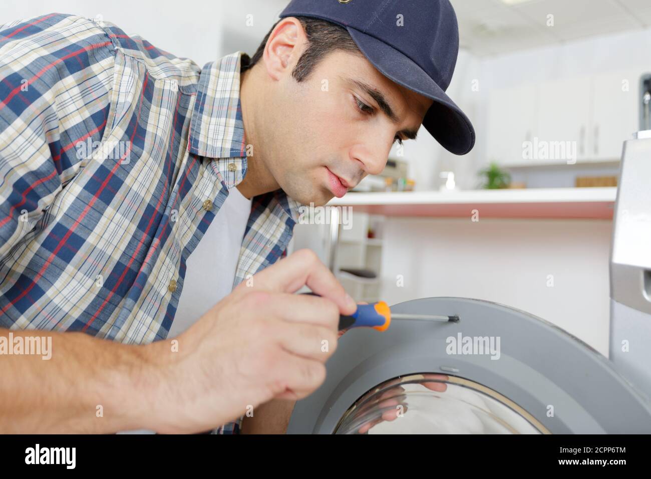 man is fixing a washing machine Stock Photo - Alamy