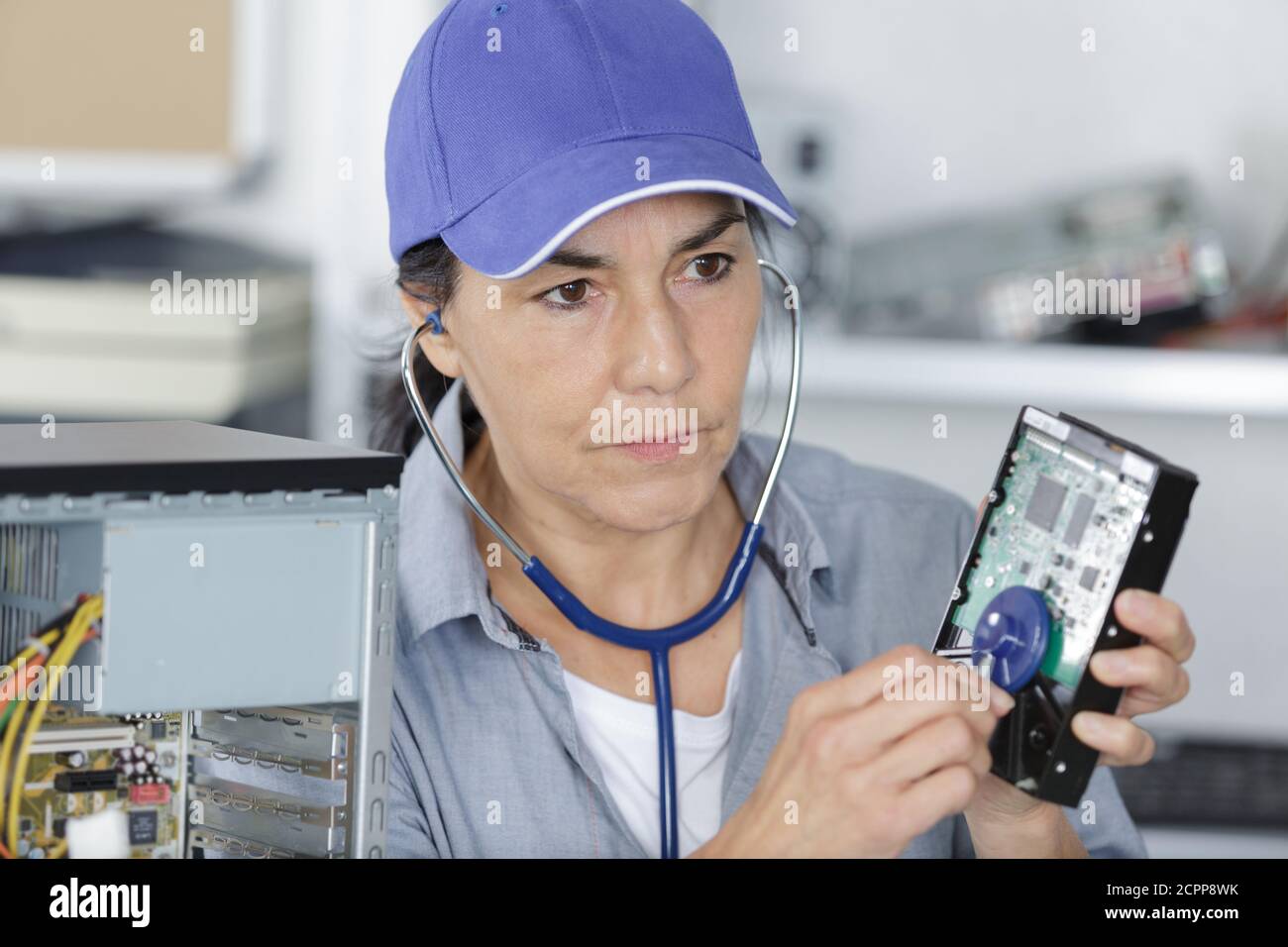 woman examining computer with stethoscope Stock Photo - Alamy