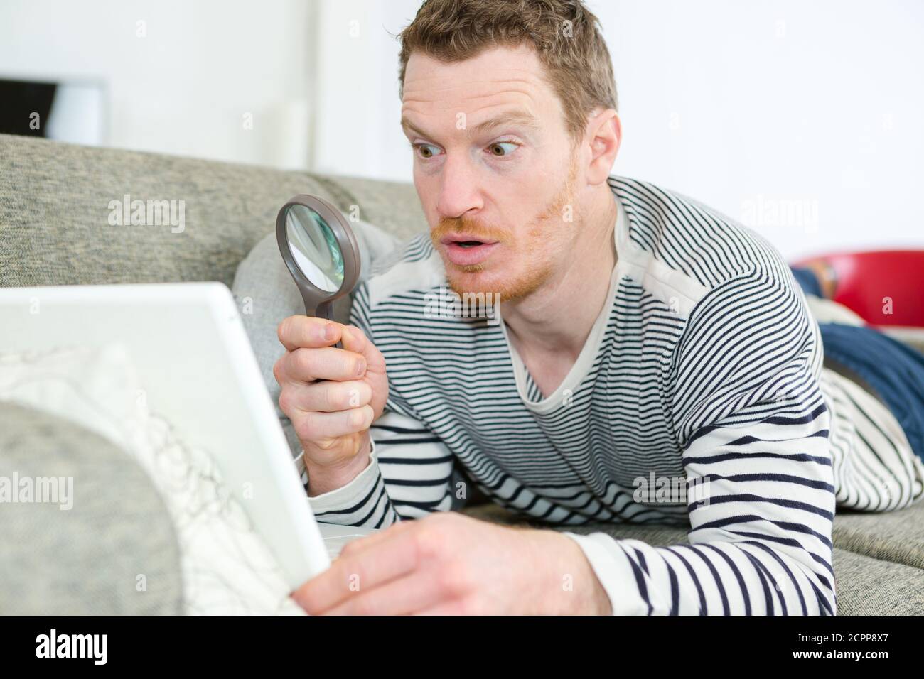 man checking finances using magnifying glass Stock Photo - Alamy
