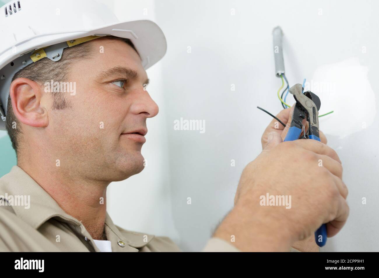 worker repairs a plug with a screwdriver Stock Photo - Alamy