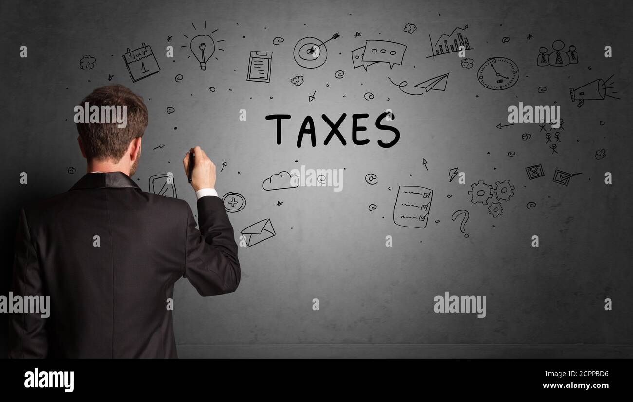 businessman drawing a creative idea sketch with TAXES inscription ...