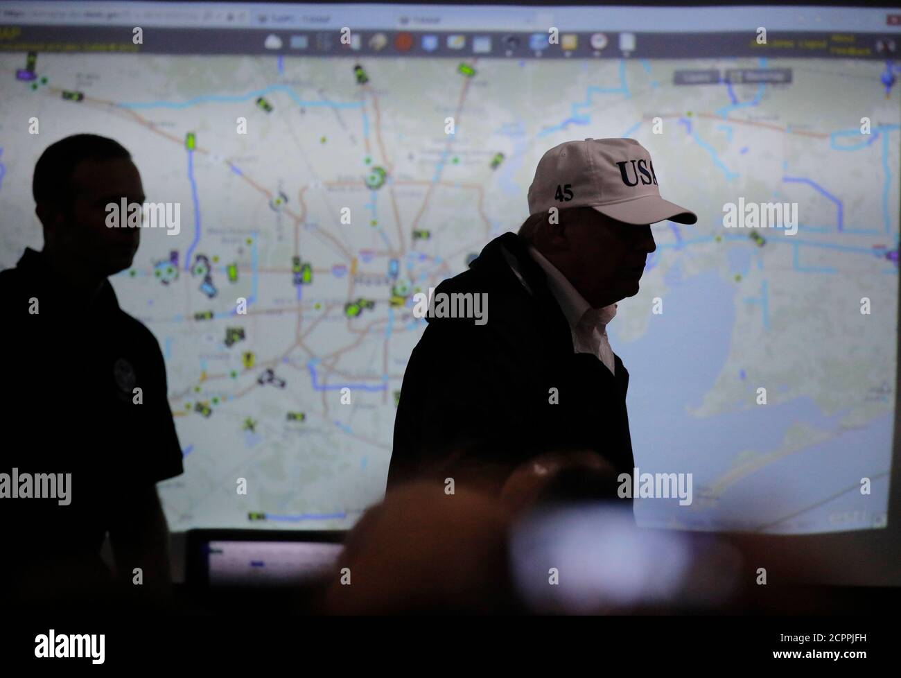 U S President Donald Trump Passes A Map Of The State Of Texas Projected On A Screen During A u-s-president-donald-trump-passes-a-map-of-the-state-of-texas-projected-on-a-screen-during-a
