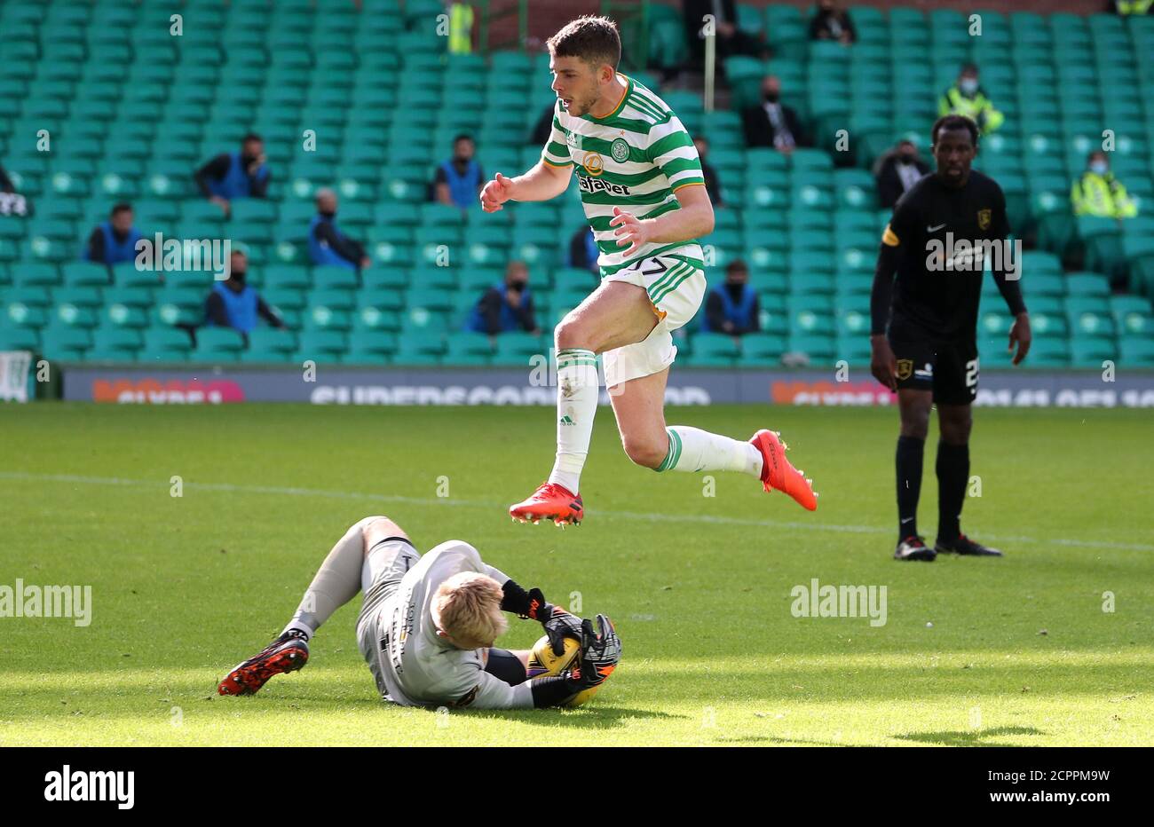 Celtic's Ryan Christie jumps over Livingston goalkeeper Robby McCrorie ...