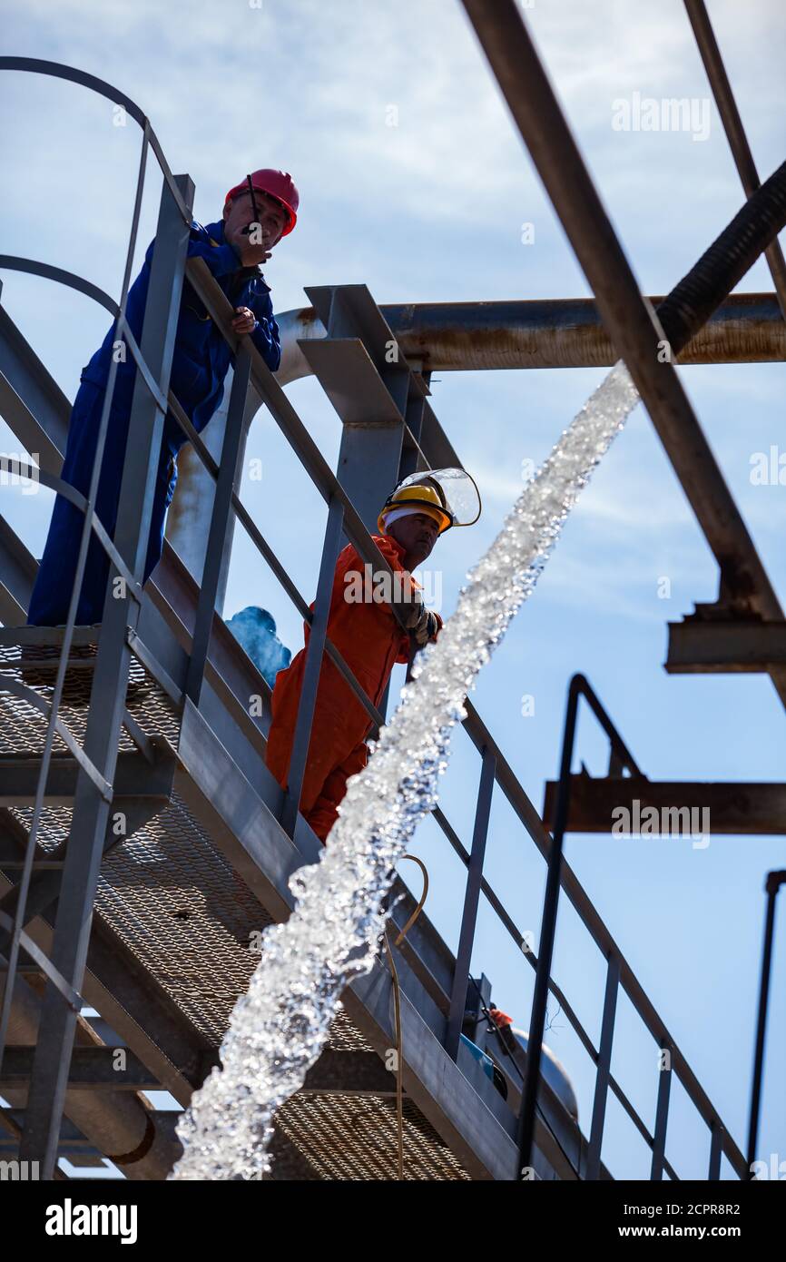 Sulphuric acid plant. Washing and cleaning up equipment tank with water ...