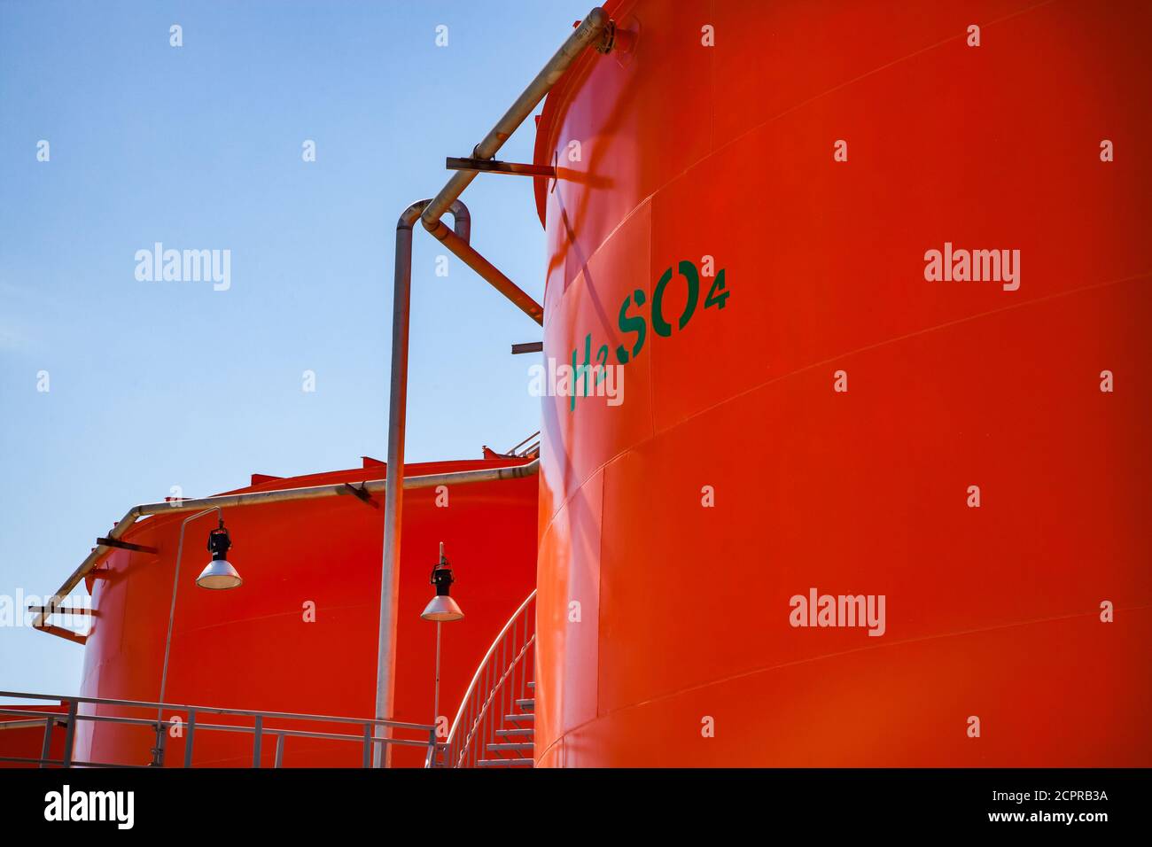 Orange metal storage tanks with sulfuric (sulphuric) acid and its ...