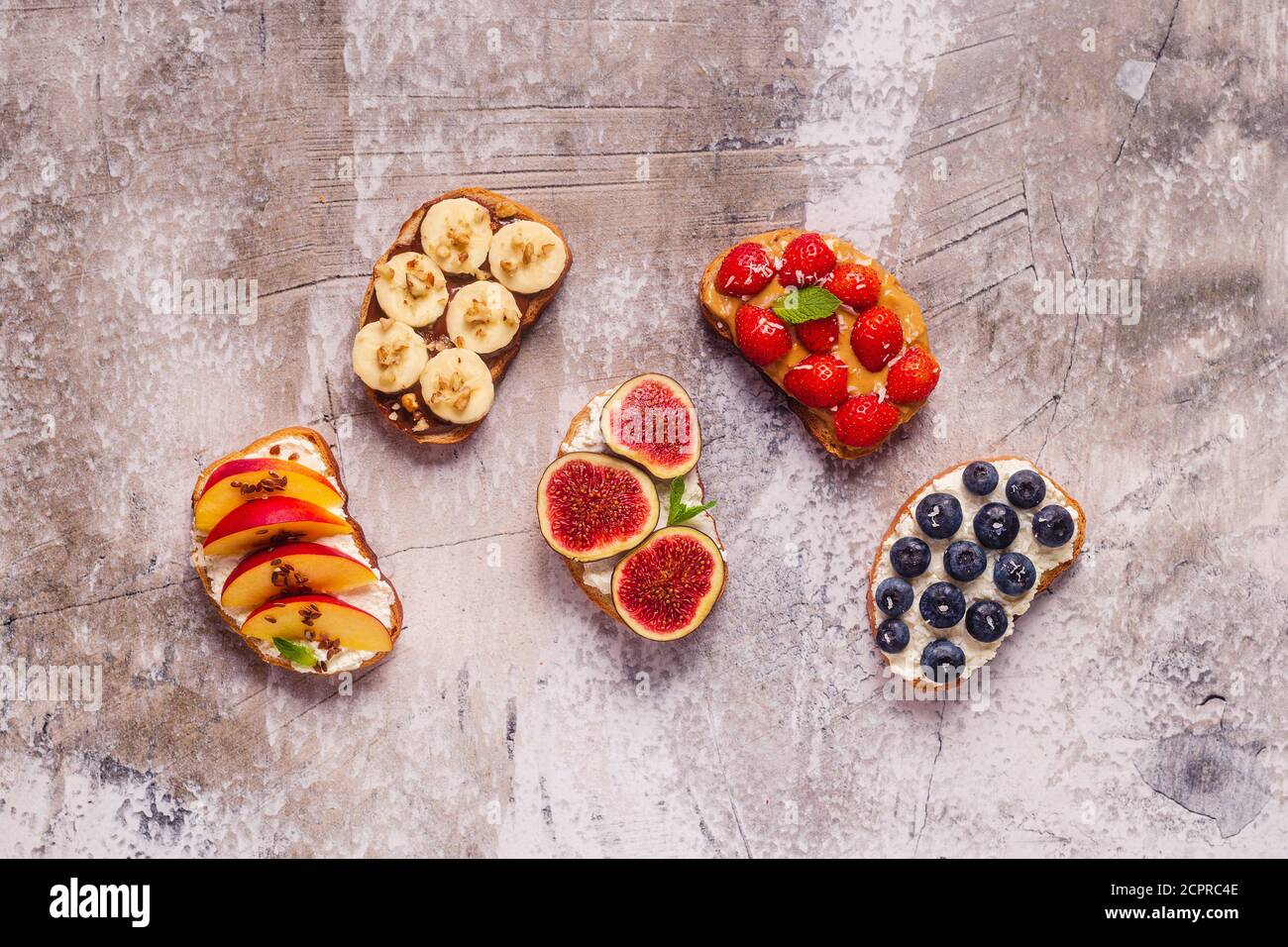 Homemade summer toast with cream cheese, nut butter and fruits and ...