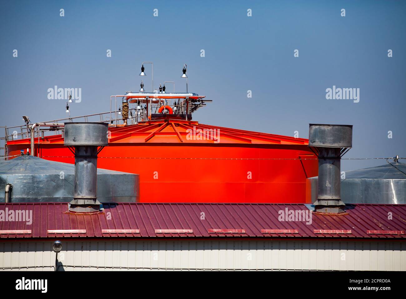 Orange steel storage tanks with acid at sulfuric acid plant warehouse ...