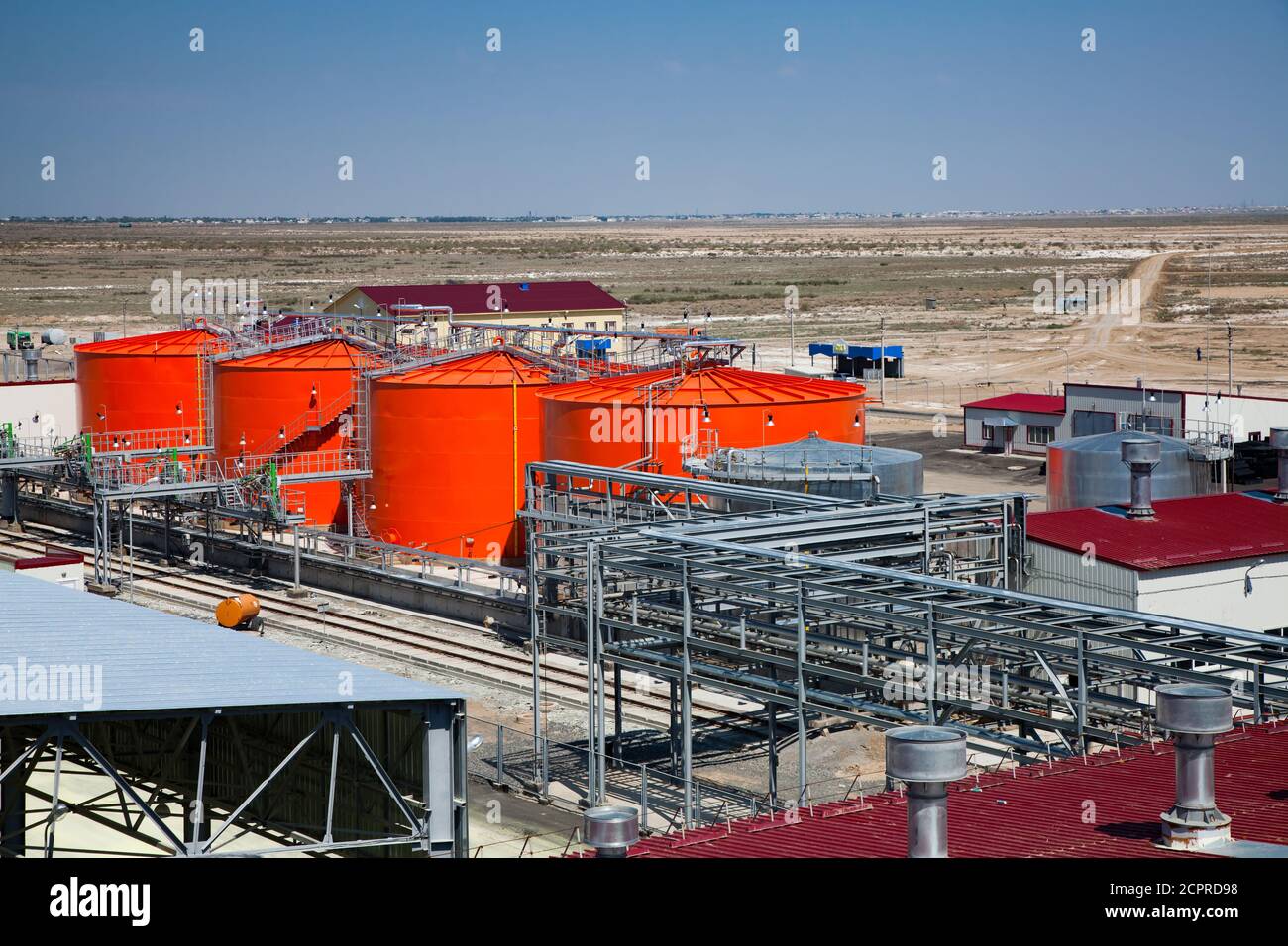 Orange steel storage tanks with acid at sulfuric (sulphuric) acid plant ...