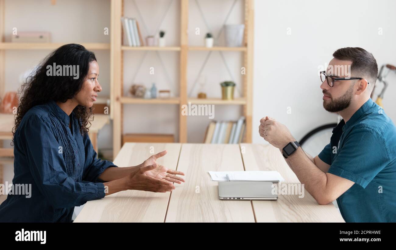 Confident hr manager holding interview with African American candidate ...