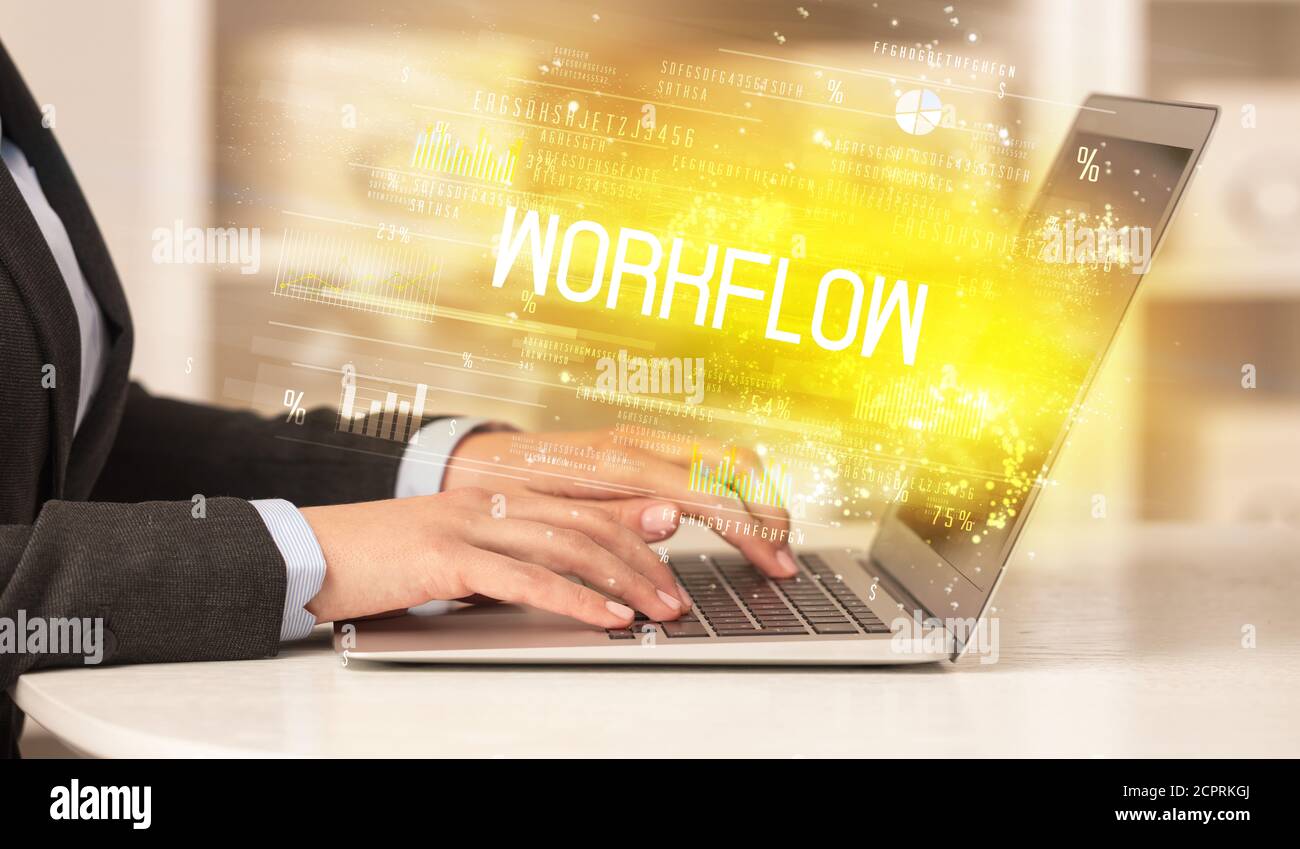 Closeup of businessman hands working on laptop with WORKFLOW ...