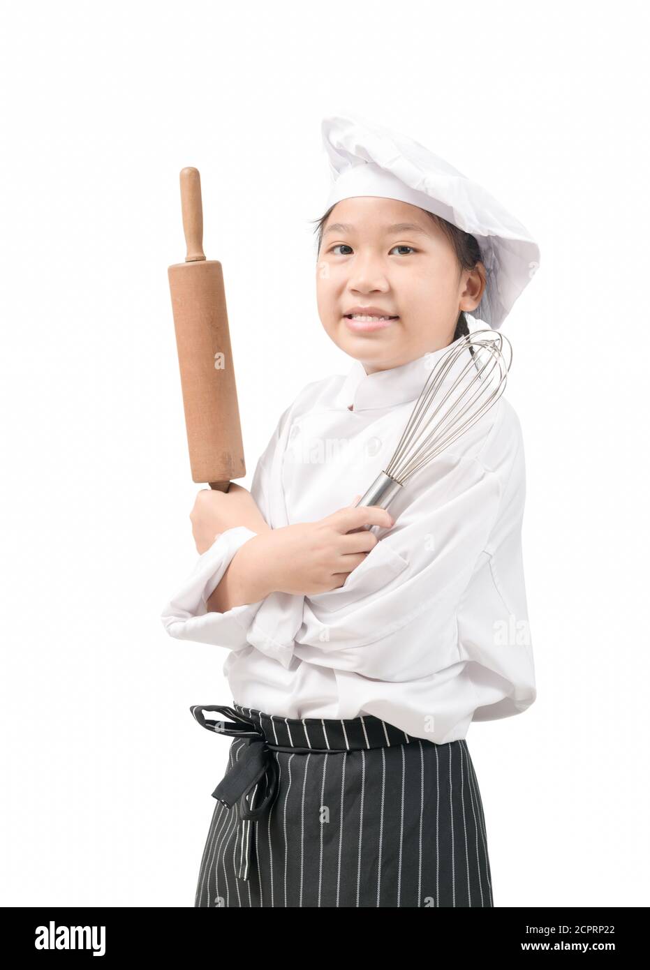 Portrait Happy little chef in uniform holding rolling pin and an egg ...