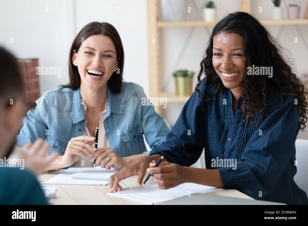 Happy diverse colleagues employees having fun at corporate meeting ...