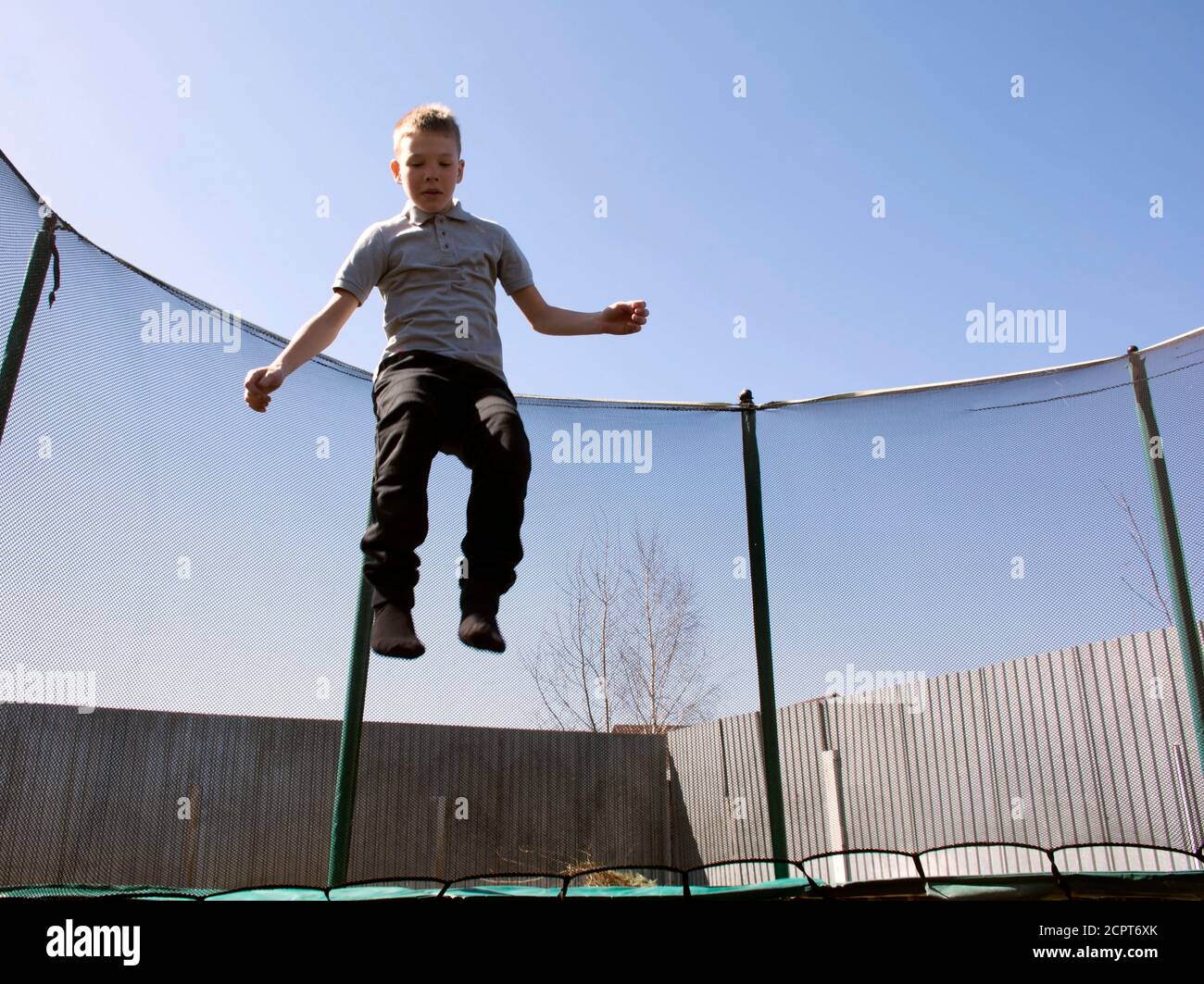 Boy jumping on a trampoline. Jumping on a trampoline Stock Photo - Alamy