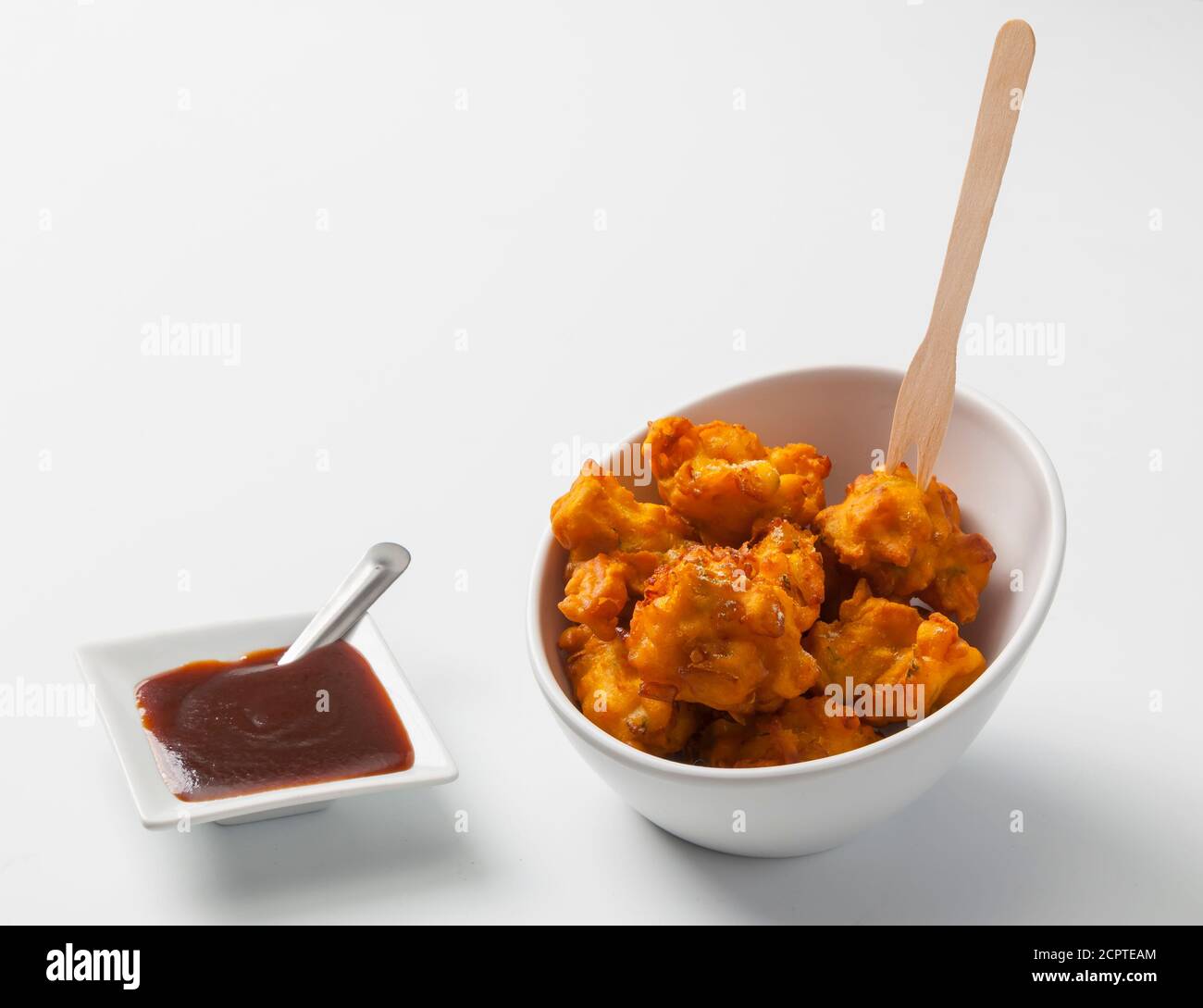 Indian pakora streetfood snack on white background Stock Photo - Alamy