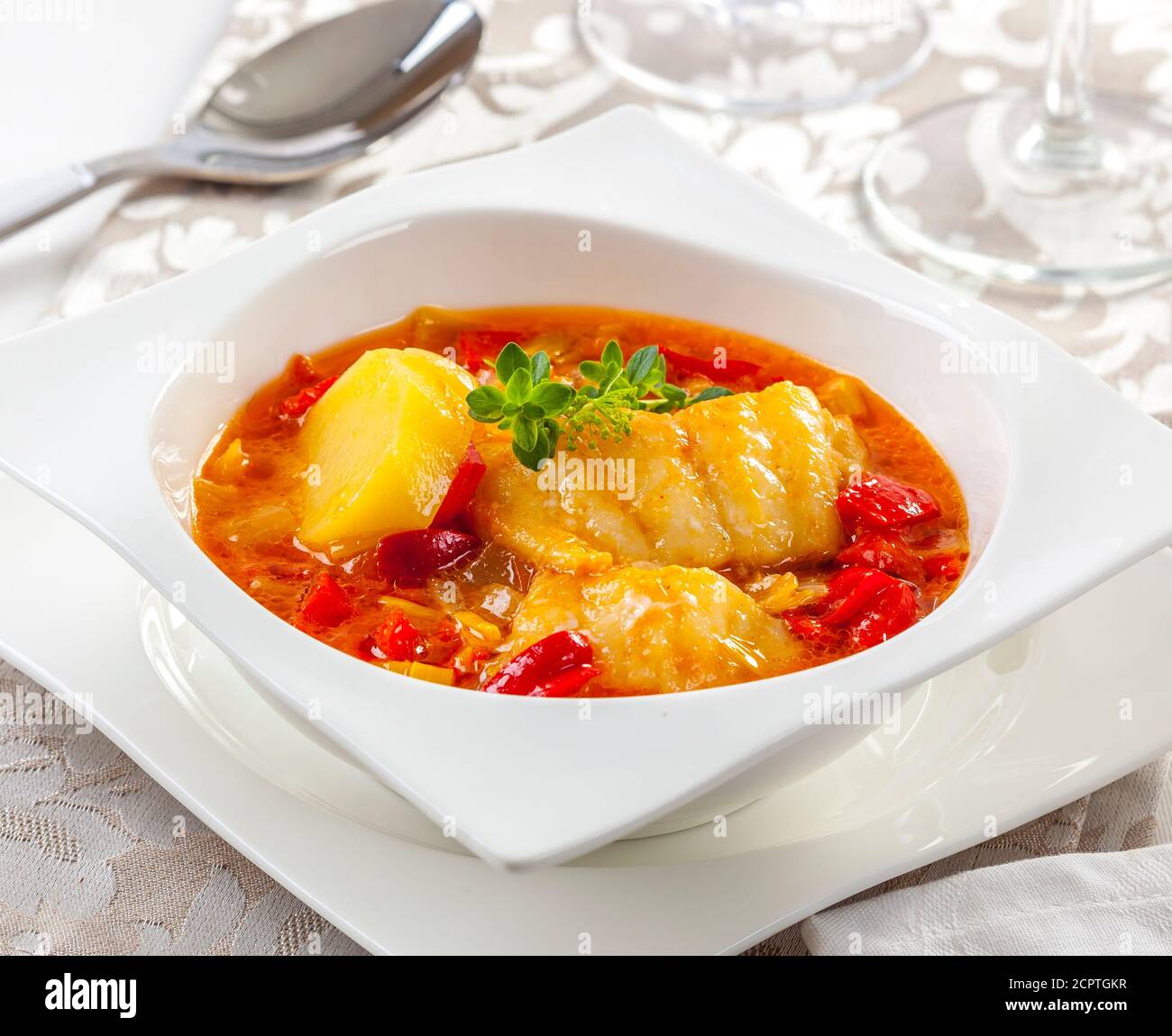 Savoury cod dish with bell pepper sauce Stock Photo - Alamy