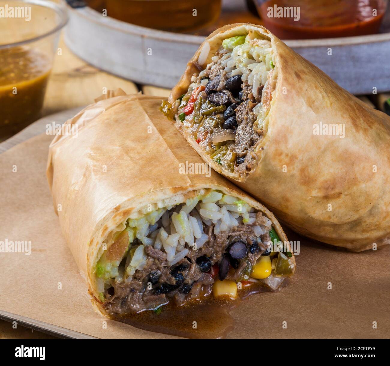 Mexican take away food. Burrito with rice, meat, frijoles and corn ...