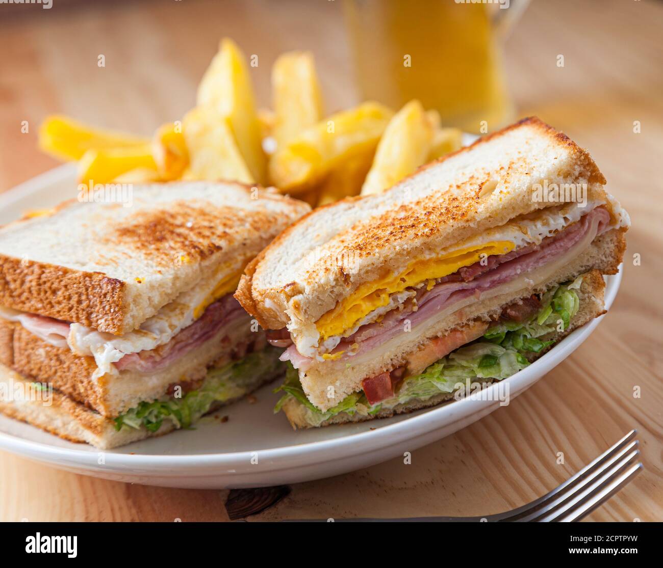 Homemade club sandwich with ham, cheese, egg, lettuce and tomato Stock ...