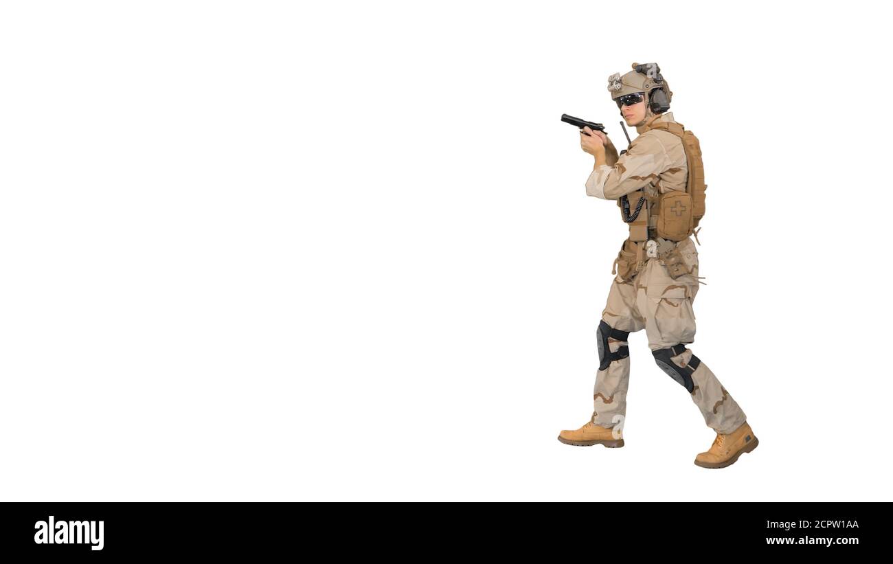 Soldier walking aiming with a pistol and shooting to camera on w Stock ...