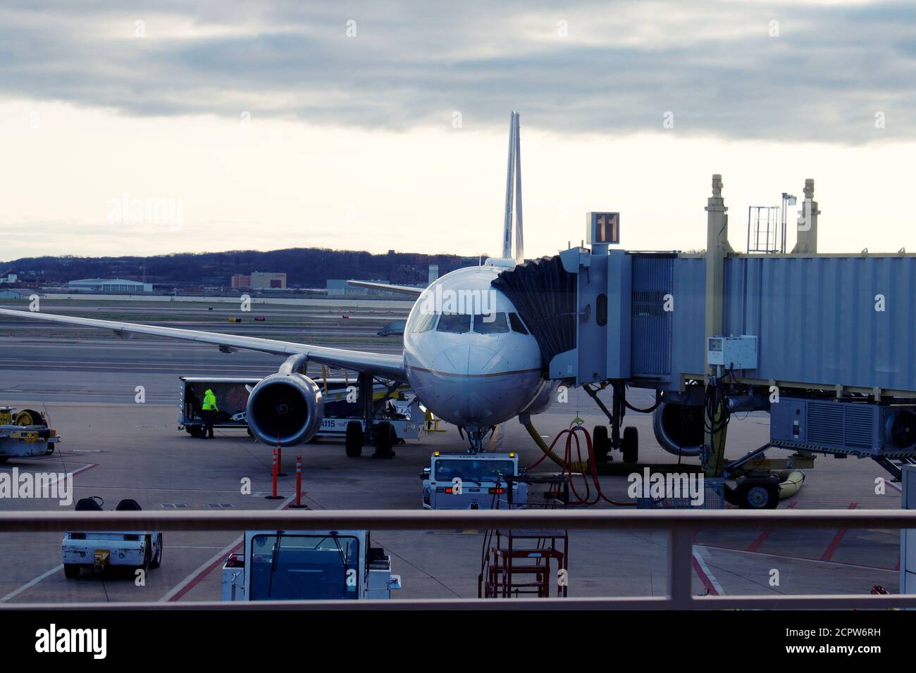 Airplane connected to jetway to unload passengers Stock Photo - Alamy