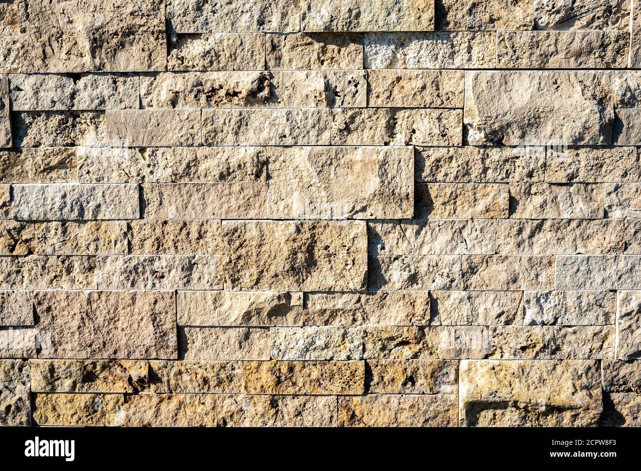 Stone wall brick texture background beige surface facade. Close - up ...