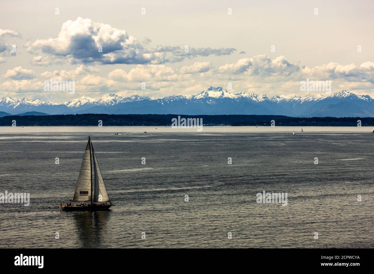 Sailboat on Puget Sound with the Olympic mountain range in the distance ...