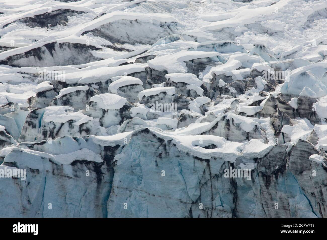 Snow sits atop the glacier edge as it meets the ocean Stock Photo - Alamy