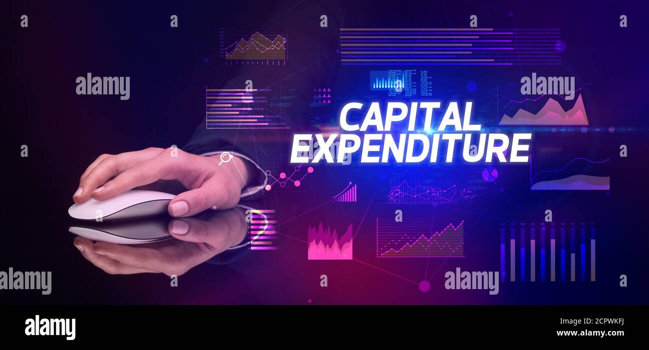 hand holding wireless peripheral with CAPITAL EXPENDITURE inscription ...