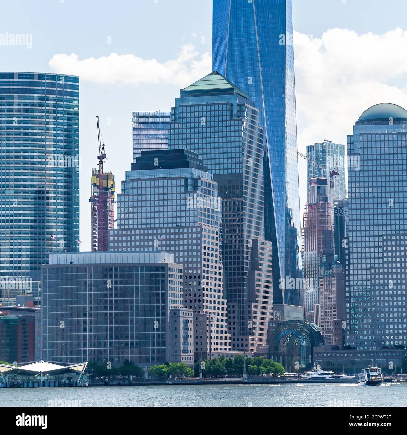 Manhattan ferry pier and buildings from hudson river during summer with ...