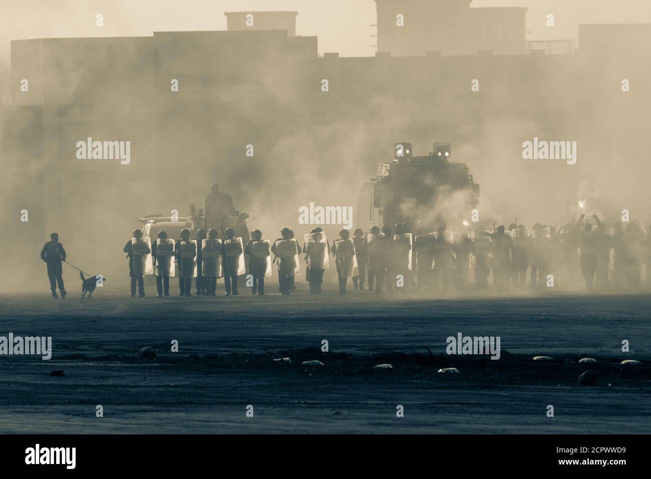 Military police riot response to a protest with tear gas, smoke, fire ...