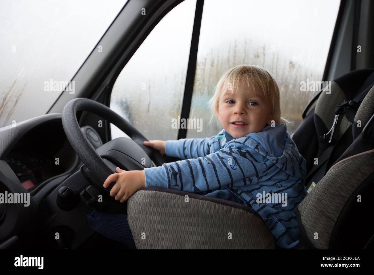 Cute toddler boy, kid driving big camper van, smiling happily Stock ...