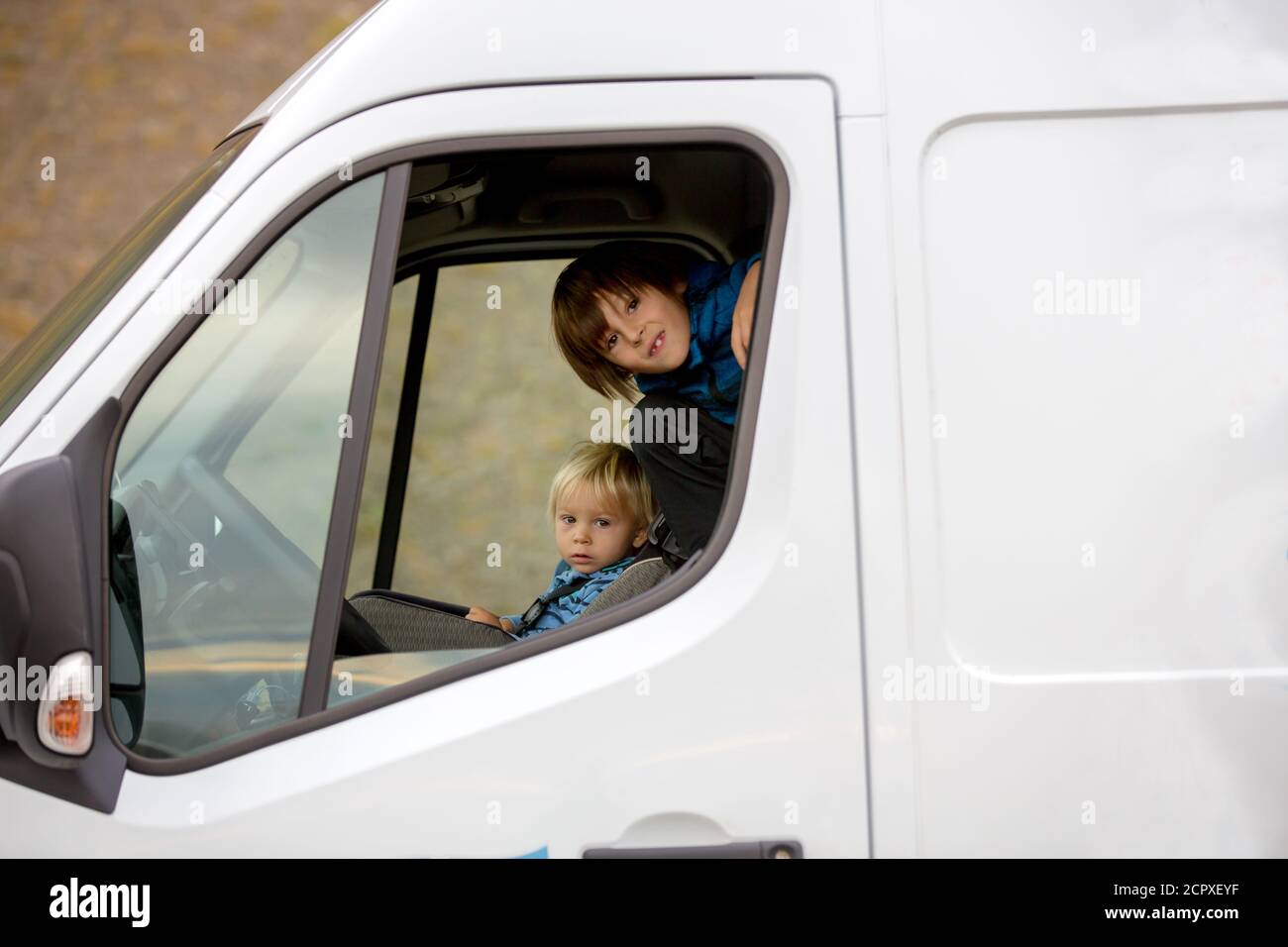 Cute boys, children in camper van traveling around Iceland autumntime ...
