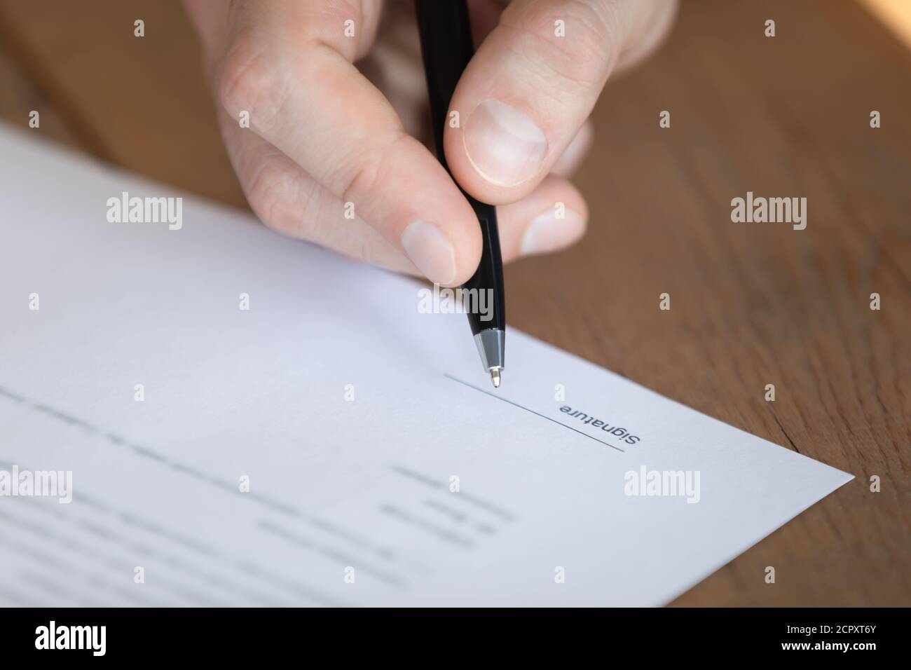 Close up of male worker put signature on contract Stock Photo - Alamy