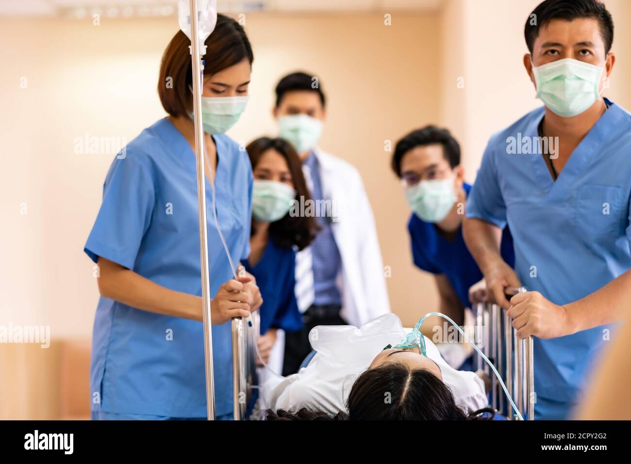 Seriously injured patient with oxygen mask on gurney stretcher bed ...