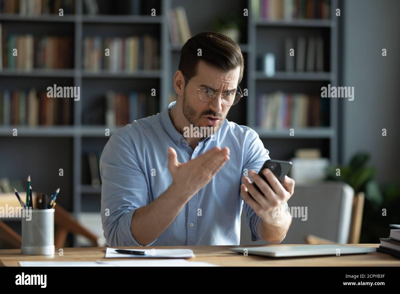 Mad man look at cell screen stressed with gadget problem Stock Photo ...