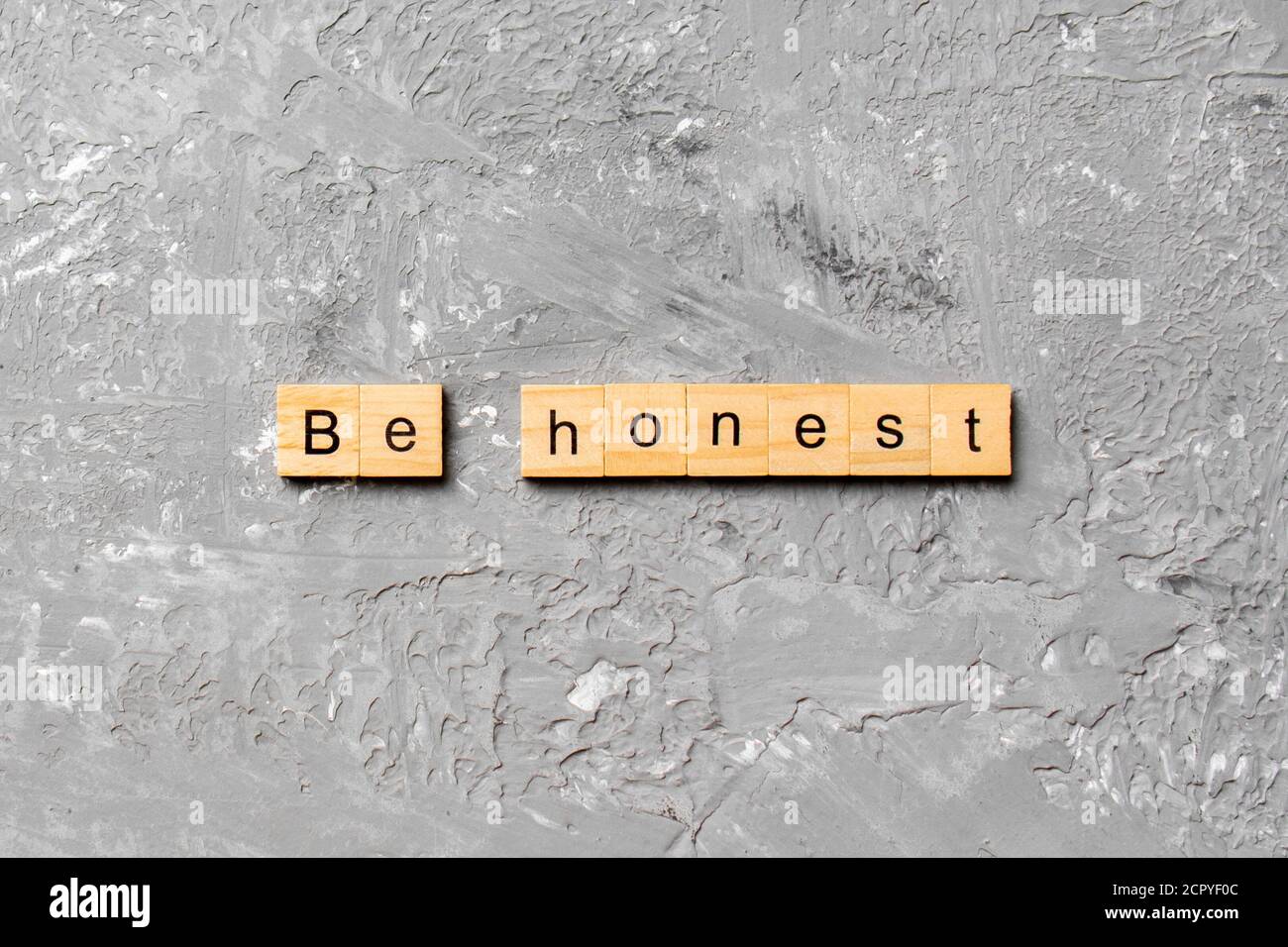 be honest word written on wood block. be honest text on table, concept ...