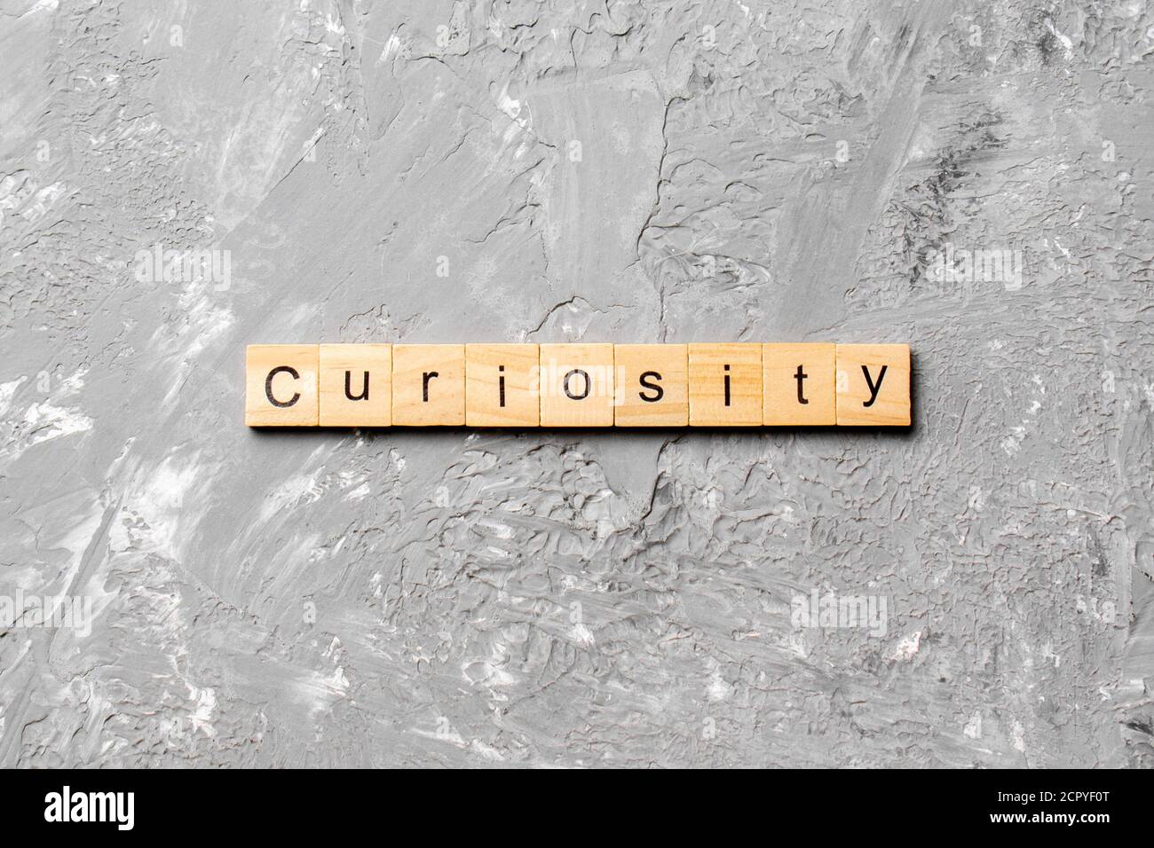 curiosity word written on wood block. curiosity text on table, concept ...