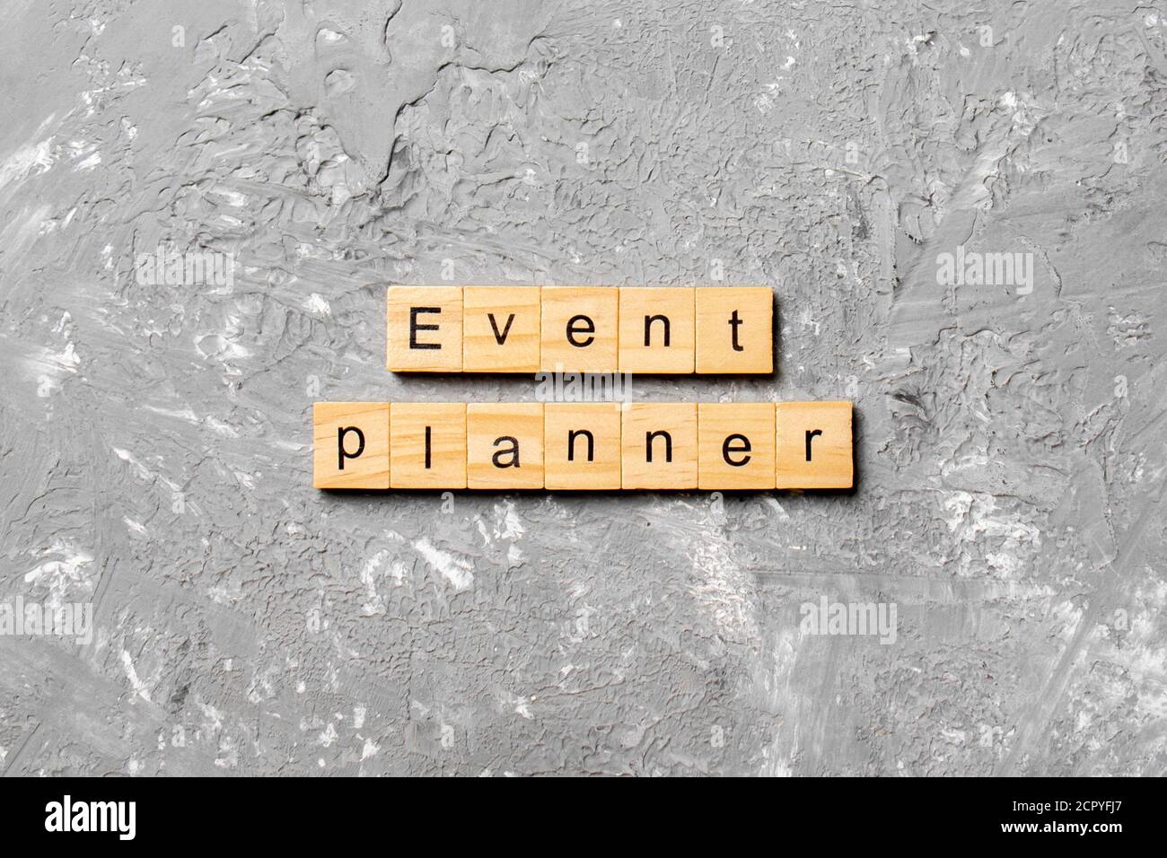 EVENT PLANNER word written on wood block. EVENT PLANNER text on cement ...