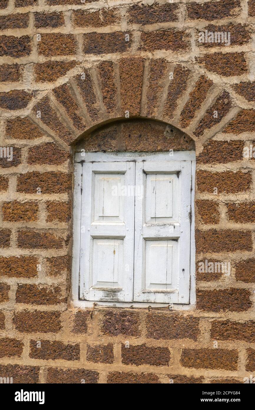 Closeup shot of an old white window on a building brick facade Stock ...