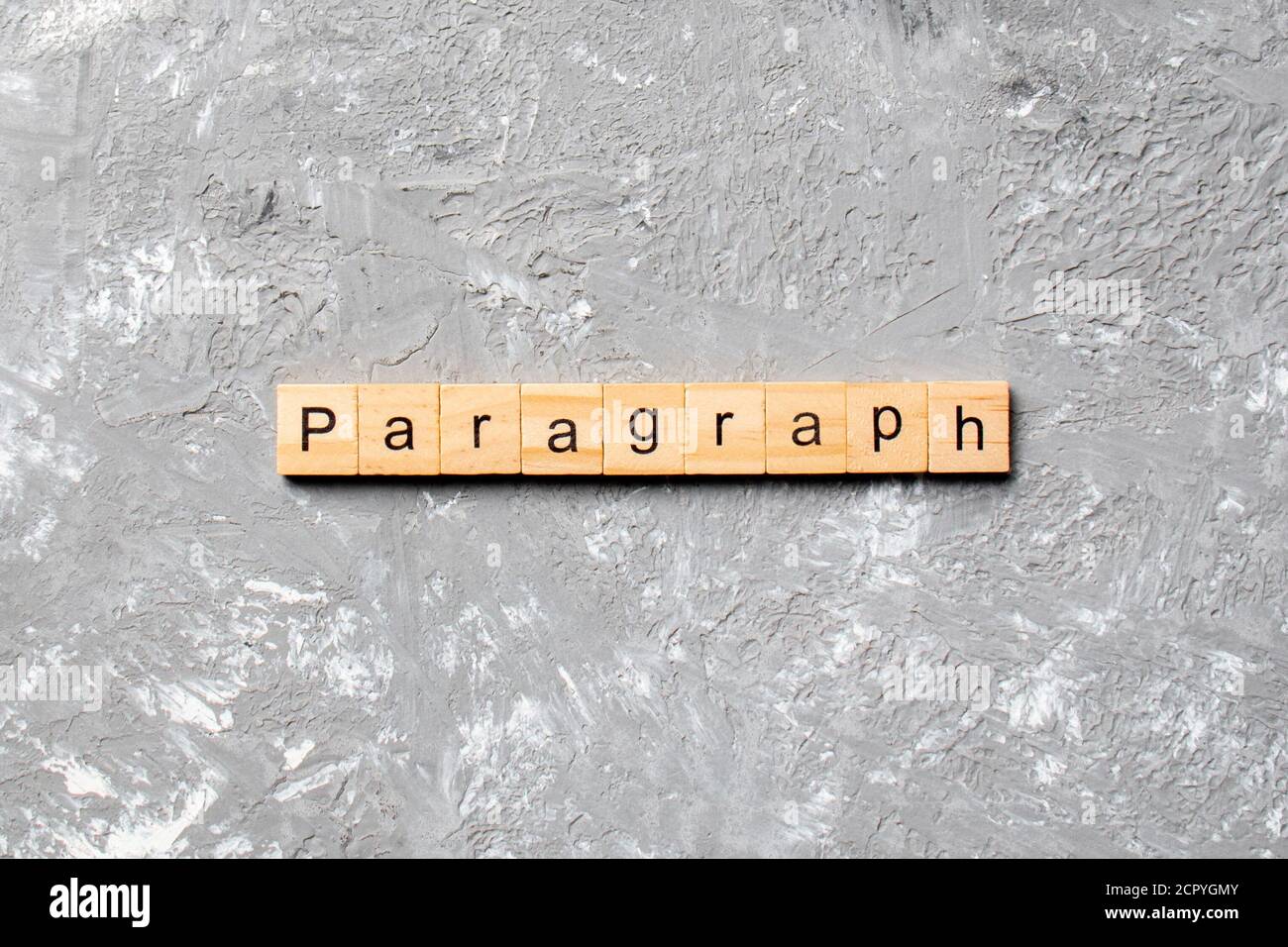 paragraph word written on wood block. paragraph text on table, concept ...