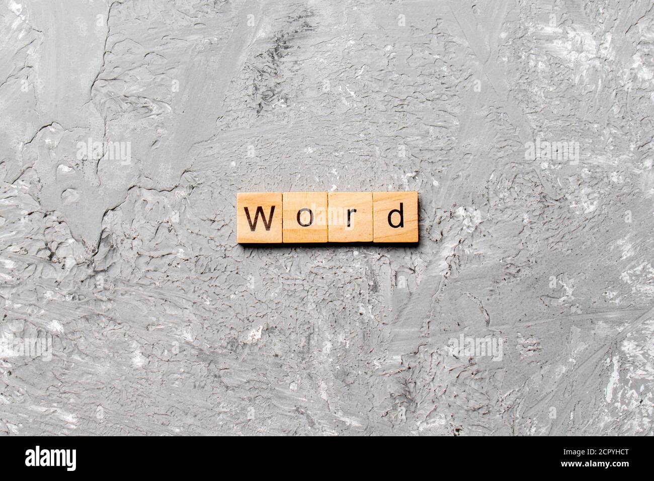 word written on wood block. WORD text on cement table for your desing ...