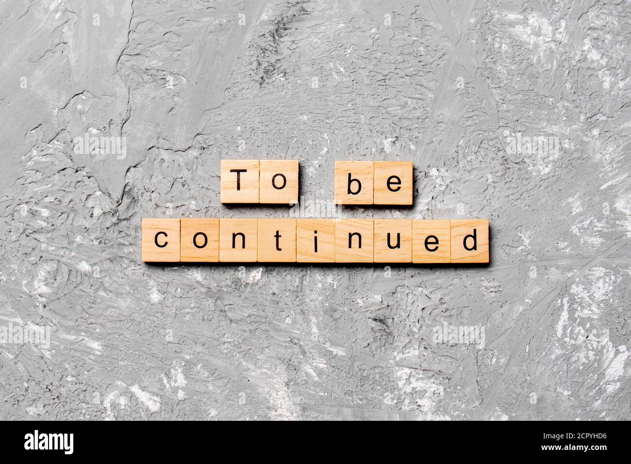 To be continued word written on wood block. To be continued text on ...