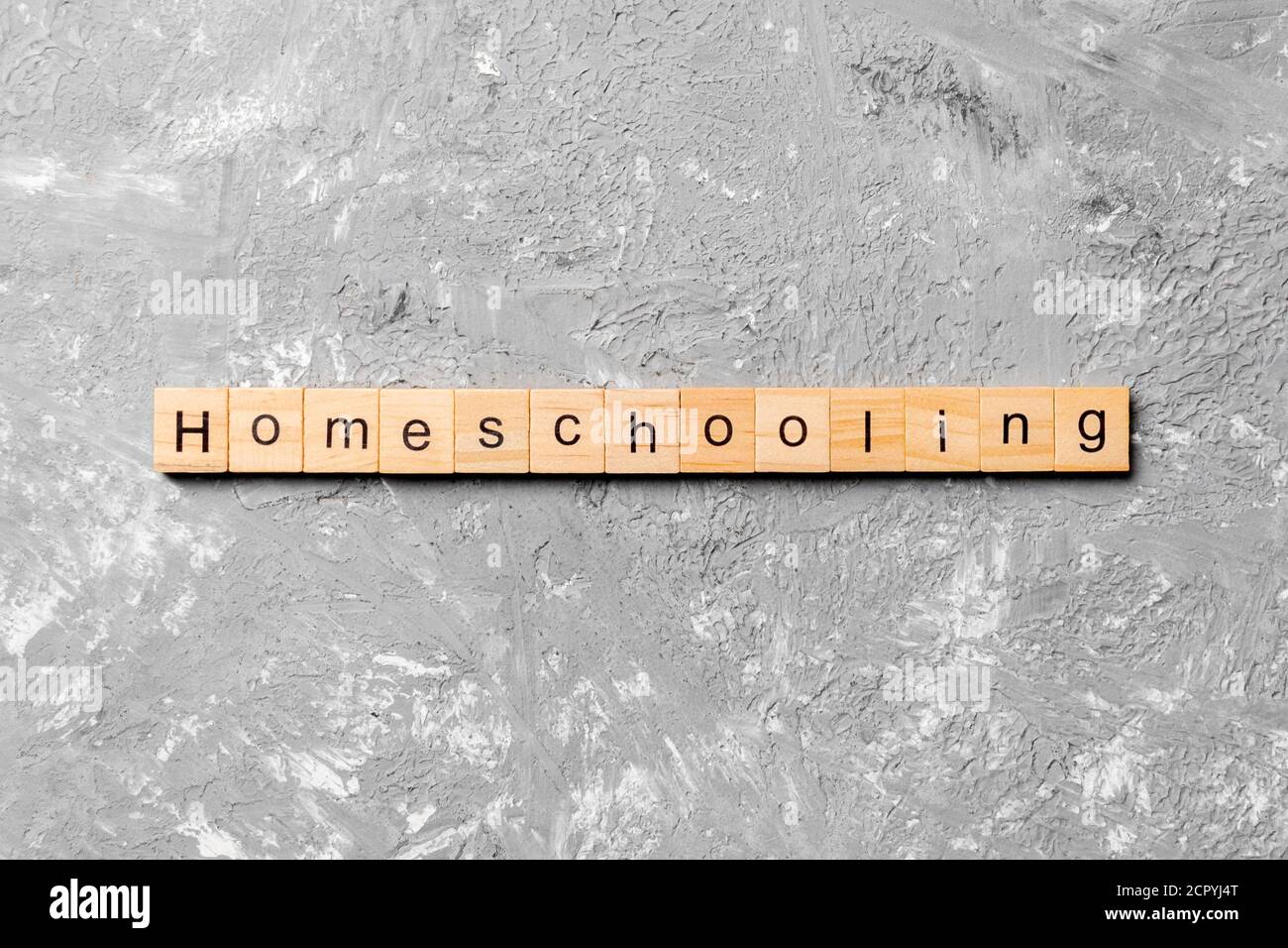 Homeschooling word written on wood block. Homeschooling text on cement ...
